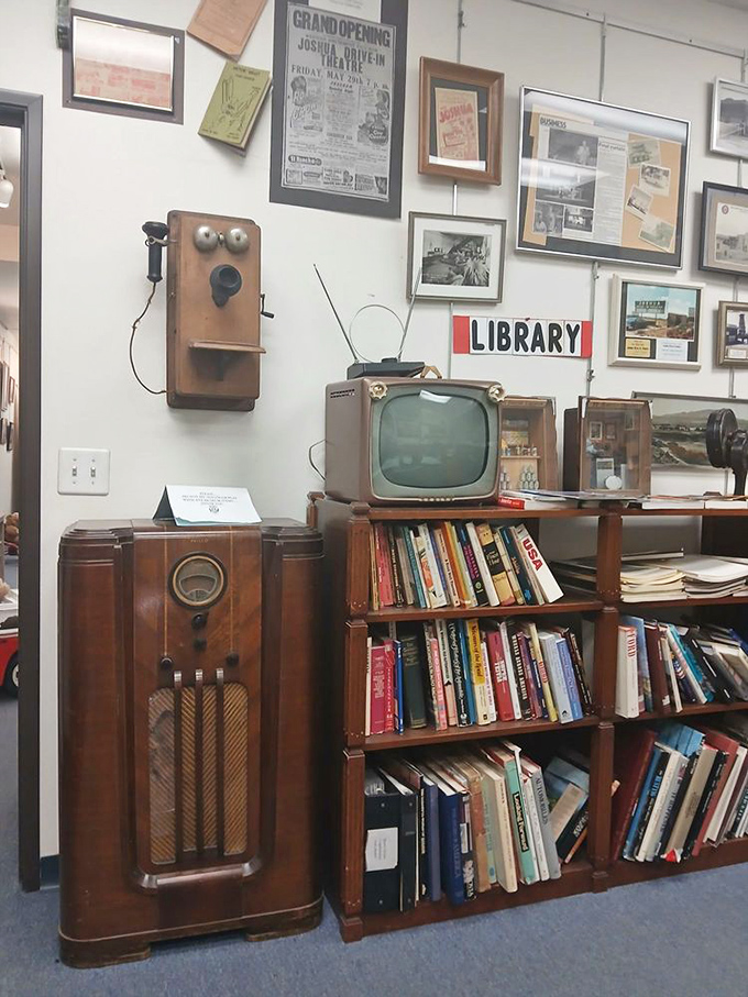 The library corner features a vintage radio, TV, and telephone&mdash;communication devices that once seemed as miraculous as today's smartphones.