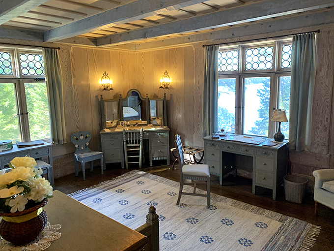 Sunlight streams through leaded glass windows, illuminating a room where the past feels present. Every piece of furniture tells a story of craftsmanship.