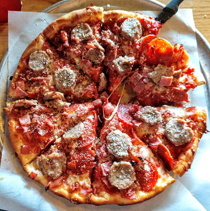 The meat lovers pizza: a carnivore's dream that would make Fred Flintstone weep with joy.