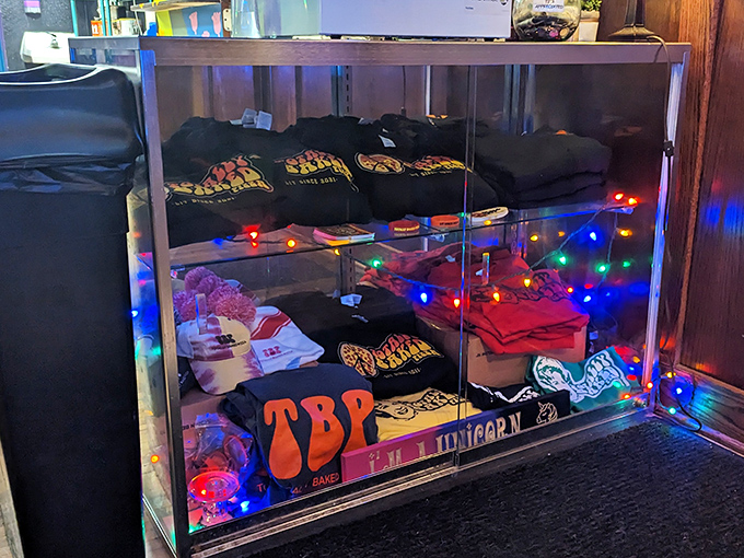 Even the merchandise display gets the full psychedelic treatment, with groovy shirts and accessories illuminated by strings of colorful lights.