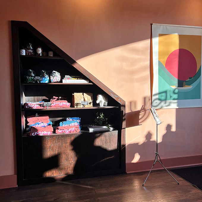 Merchandise that lets you take home a piece of the Joya's experience, displayed in a space where shadows dance with sunlight.