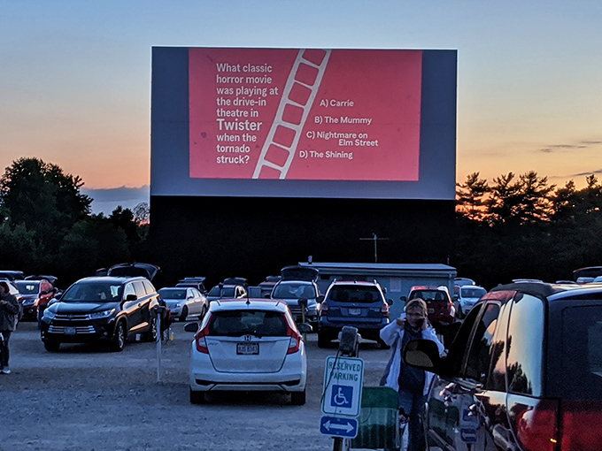 Movie trivia illuminates the massive screen, turning film buffs into competitive contestants before the main attraction begins.