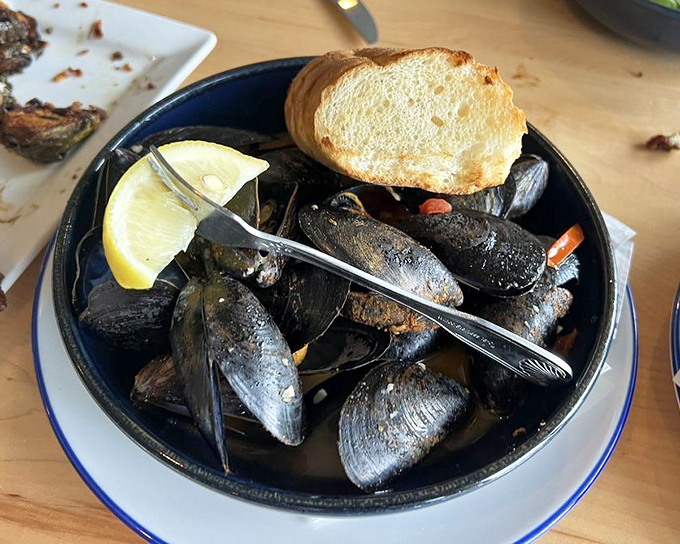 These mussels aren't just served&mdash;they're presented like the maritime treasures they are, complete with crusty bread for that essential sauce-sopping.