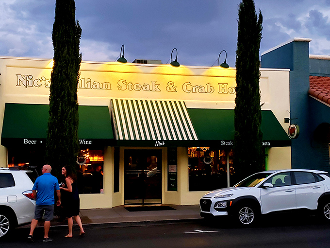 Nic's Italian Steak & Crab House stands ready for dinner service, its cypress trees standing sentinel like culinary guardians of good taste.