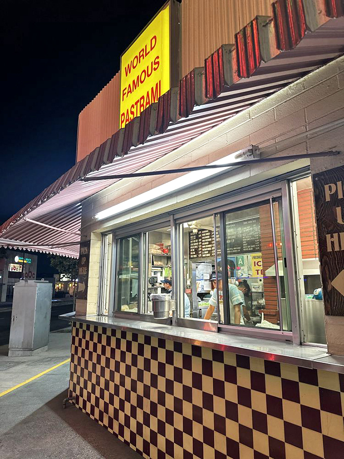 Night or day, this ordering counter beckons hungry souls with its checkerboard charm and promises of pastrami perfection.