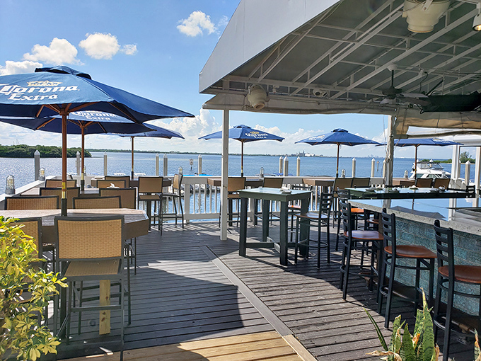 Waterfront dining that makes you wonder why you ever eat indoors. Those blue umbrellas aren't just for shade&mdash;they're framing devices for your Instagram story.