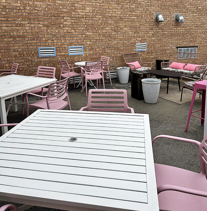 The brick-walled patio offers an urban oasis for burger contemplation. Those pink chairs aren't just stylish&mdash;they're comfortable thrones from which to rule your lunchtime kingdom.