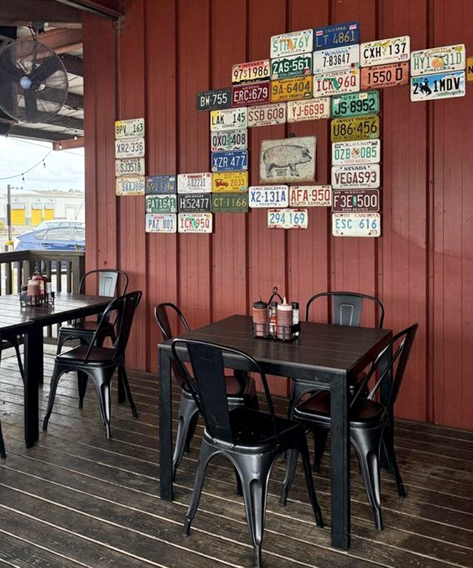 License plates form a makeshift American flag on this outdoor patio wall. Each one represents a road trip that wisely ended right here at this table.