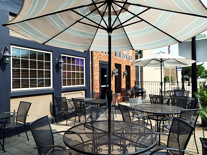 The patio where summer evenings stretch into memory-making territory. Those umbrellas aren't just blocking sun&mdash;they're creating personal dining oases.