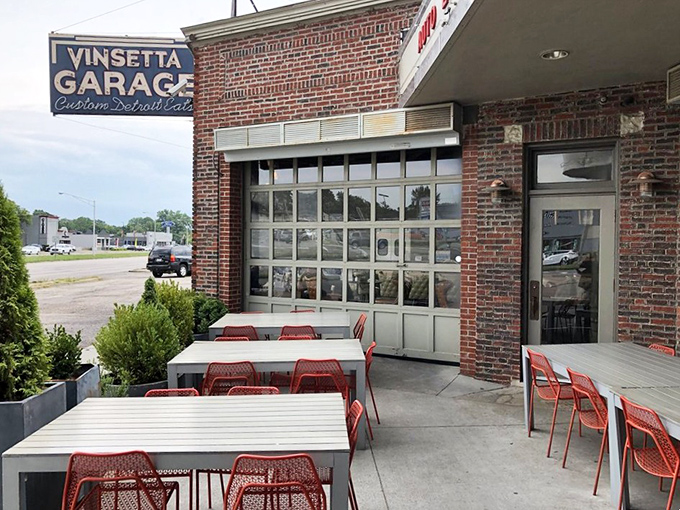 Al fresco dining with a side of automotive history. The garage doors open to create a patio experience that's pure Michigan&mdash;casual, cool, and completely charming.