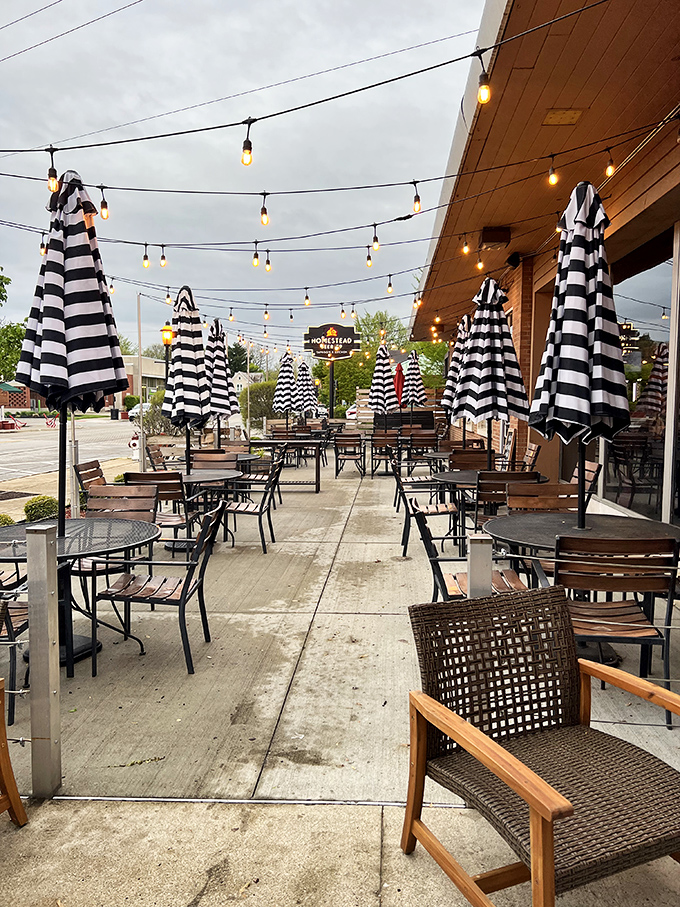 The patio at dusk, when string lights twinkle like stars and those striped umbrellas stand ready for tomorrow's sunshine.