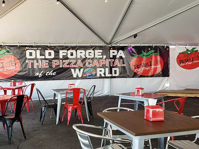 The outdoor seating area proudly displays Old Forge's self-proclaimed title—"The Pizza Capital of the World"—a bold claim backed by rectangular evidence.