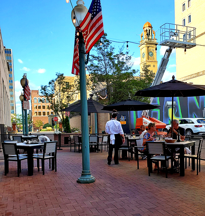 Outdoor dining with a view of Canton's historic architecture—American flags fluttering above as servers deliver plates of perfection.