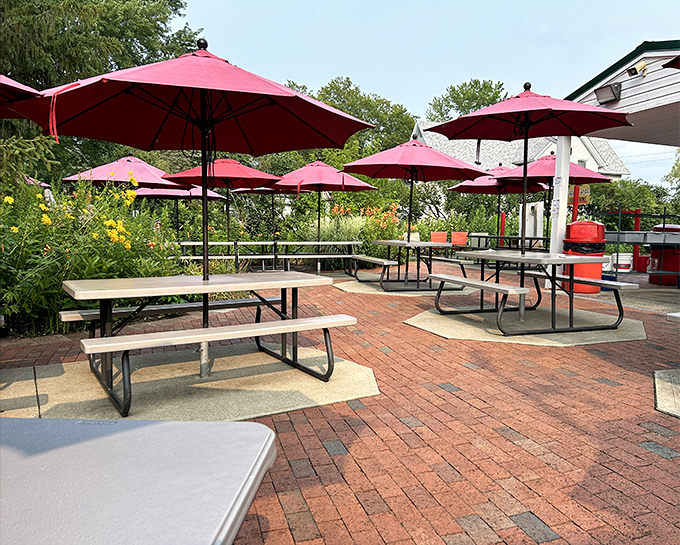 Red umbrellas standing guard over picnic tables where countless "remember whens" have been born between bites of perfect summer food.