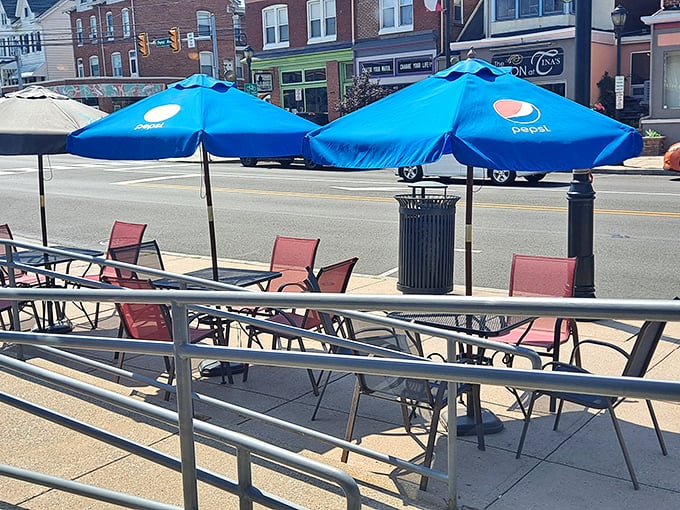 The outdoor seating area offers a front-row view of West Reading's charming streetscape. Those blue umbrellas provide shade for both conversations and comfort food.