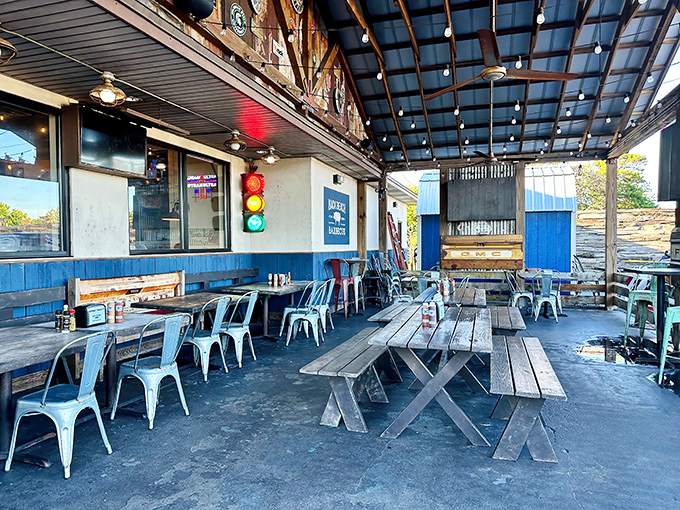 Outdoor picnic tables under string lights&mdash;because barbecue tastes 20% better with a Gulf breeze and the sound of vacation all around.