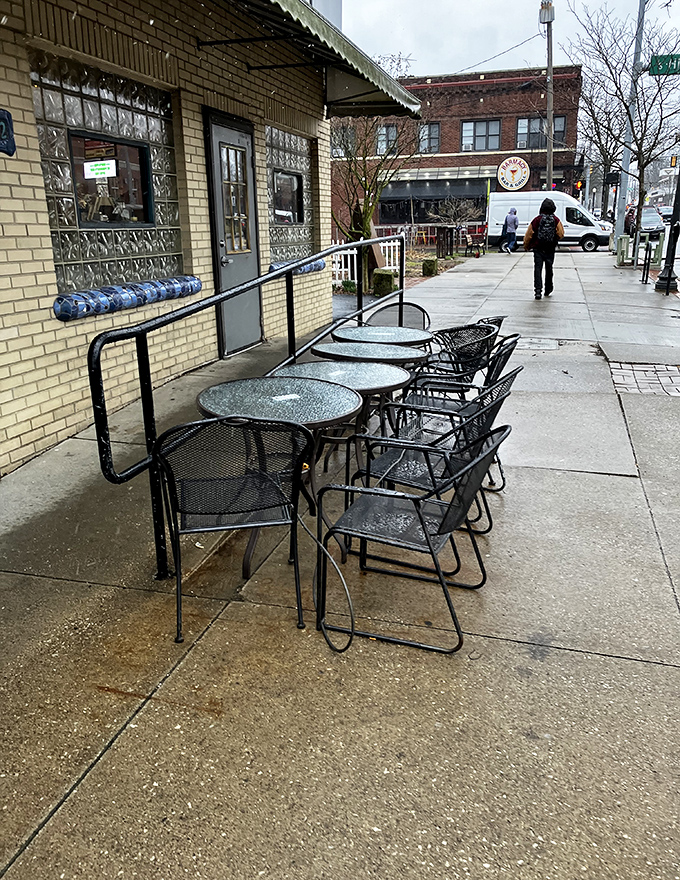 Rain or shine, these sidewalk tables offer front-row seats to Highland Square's daily parade of characters and conversations.