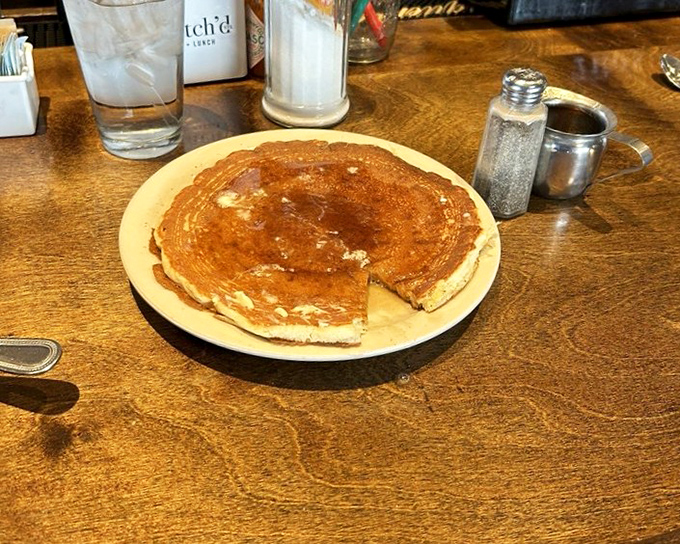 The humble pancake, elevated to art form—golden, fluffy, and ready for its maple syrup waterfall moment. Breakfast doesn't get more classic than this.