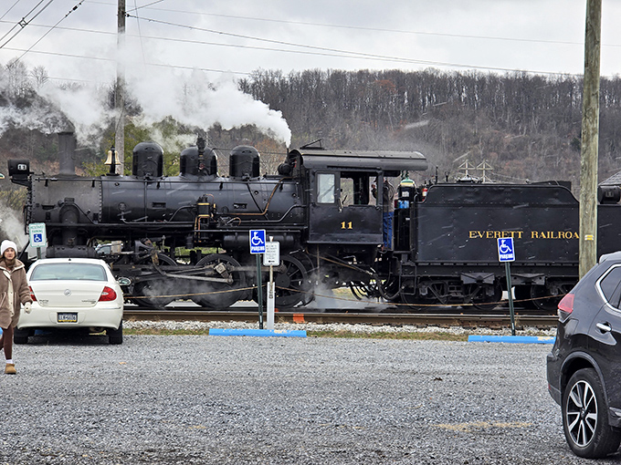 Steam billows dramatically as No. 11 prepares for departure, a mechanical performer ready for its daily show.