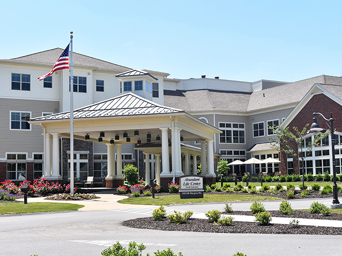 The Passavant Community's welcoming entrance combines classic colonial architecture with meticulous landscaping&mdash;retirement living that doesn't scream "retirement."