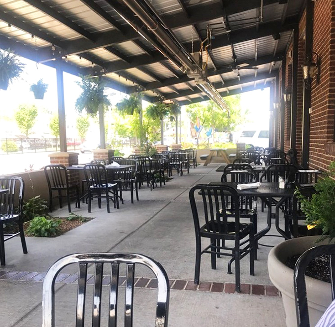 The covered patio offers al fresco dining without the sunburn. Plants and brick columns create an urban oasis just steps from the main dining room.