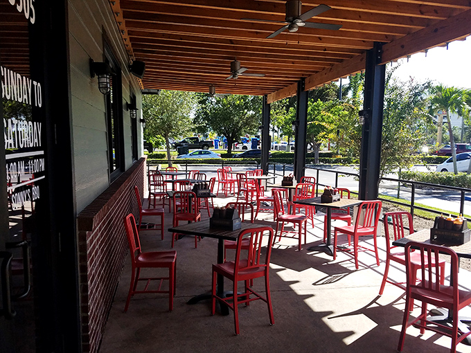 Outdoor seating where the Florida breeze carries hints of smoke from the pits. Even the palm trees seem to lean in for a whiff.