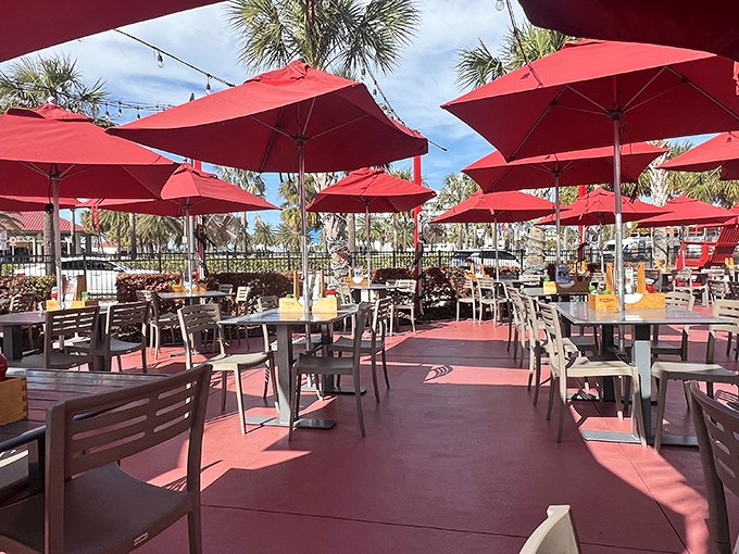 Red umbrellas create an outdoor oasis that says, "Yes, you can have another cocktail&mdash;you're on Florida time now."