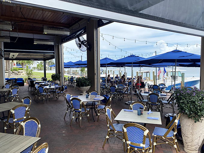 The patio seating at Dry Dock proves that dining al fresco with a water view makes everything taste 37% better.