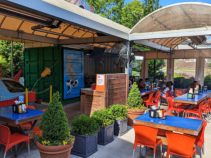The colorful outdoor patio offers a cheerful escape. Those bright orange chairs practically shout "sit here and enjoy something delicious!"