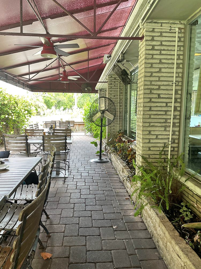 The patio offers a shaded retreat where ceiling fans stir the Florida air just enough to make lingering over that second cup of coffee inevitable.