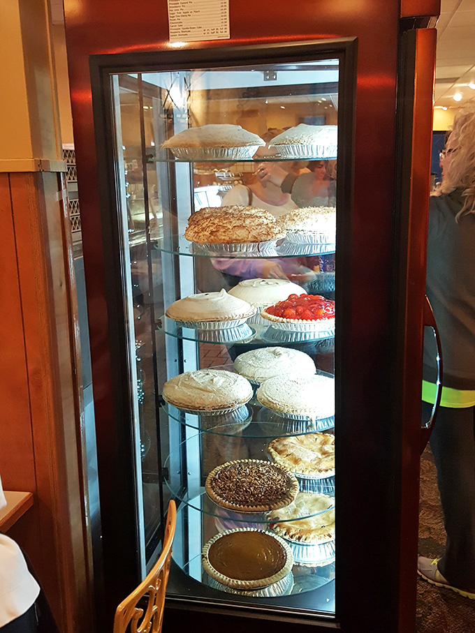 The pie case &ndash; a rotating gallery of edible art where fruit, cream, and meringue masterpieces await their moment of glory on your tray.