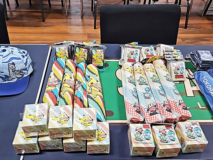 Tournament supplies laid out like a general's battle plan. The Pikachu playmat? That's just psychological warfare in cute yellow form.