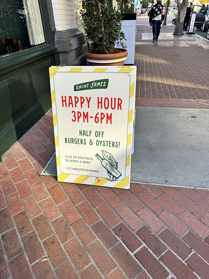 Half-price burgers AND oysters? This happy hour sign isn't just an announcement—it's practically a public service.