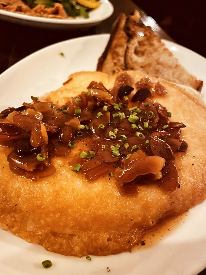 This isn't just melted cheese—it's provoleta having its moment in the spotlight. Caramelized onions and fresh herbs take this from snack to sensation.