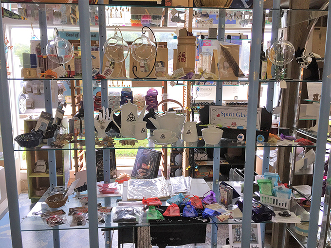 Spiritual statues meet quirky collectibles on lime-green shelves. From Buddha to Day of the Dead, this booth embraces eclectic with open arms.