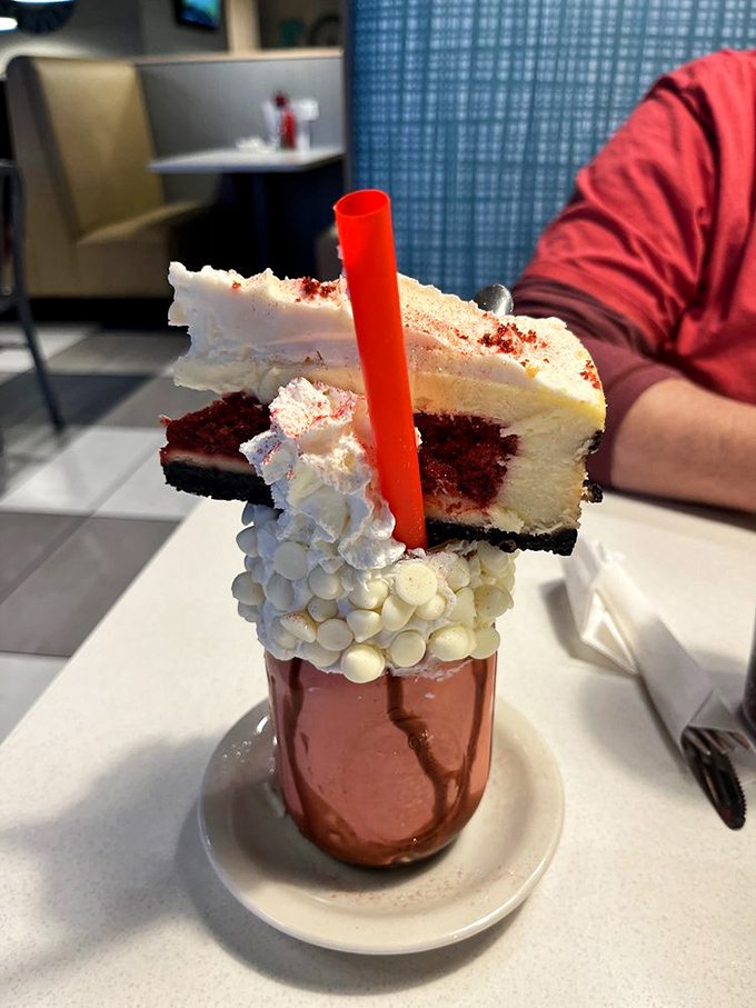 Not just a milkshake but a structural engineering marvel&mdash;red velvet cake balanced atop whipped cream that's worth every calorie and Instagram like.