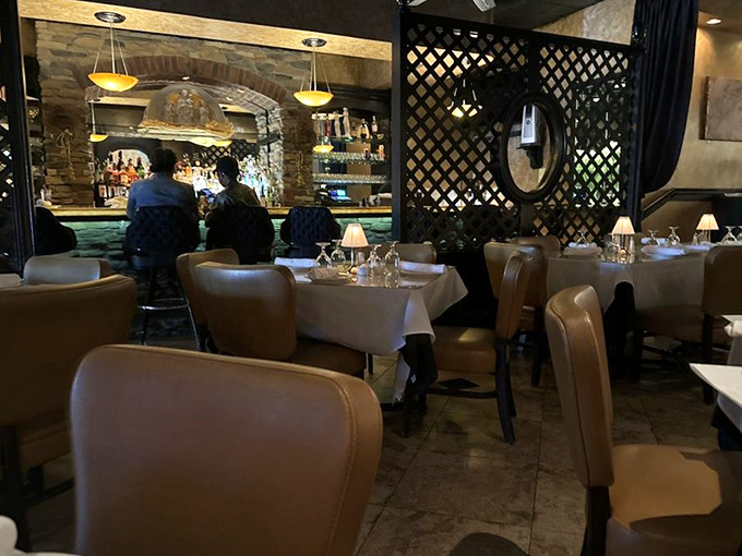 The lattice dividers and intimate lighting create distinct dining areas that somehow feel both private and part of the larger community.