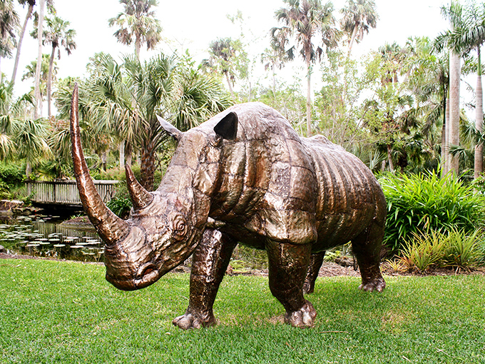 This magnificent rhinoceros sculpture stands guard over the garden. Metal transformed into muscle, power frozen in time.