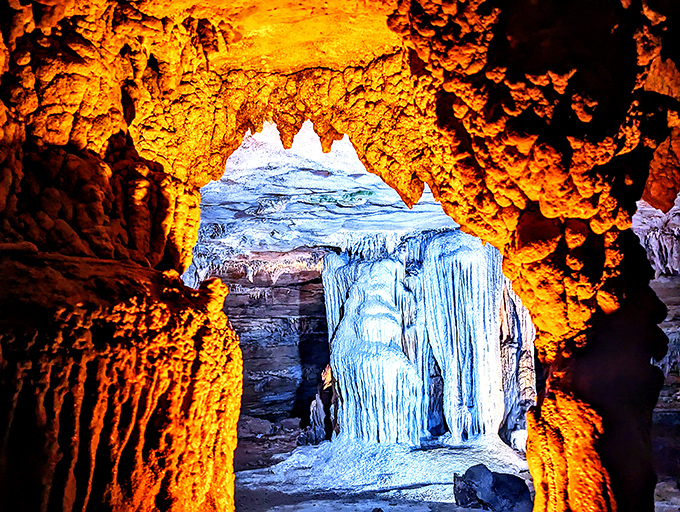 Fire and ice vibes in this dramatically lit passageway. The contrasting orange and blue lighting transforms mineral deposits into otherworldly art.