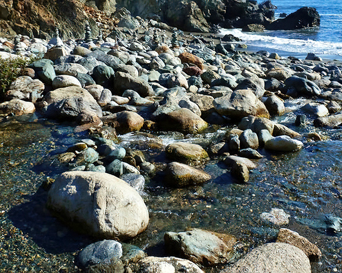 Where ocean meets shore in a symphony of smooth stones. Nature's most soothing soundtrack plays here 24/7, no subscription required.
