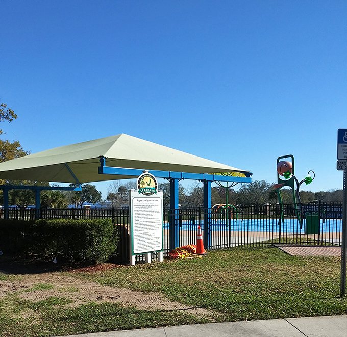 Summer heat solution: The splash pad where grandkids play while you stay dry under nearby shade. Retirement planning at its finest.