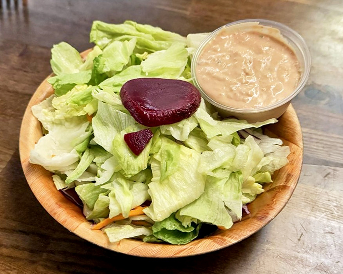 A salad that knows its role&mdash;bringing just enough virtue to justify what comes next. That beet slice adds color and the suggestion that you're making healthy choices.