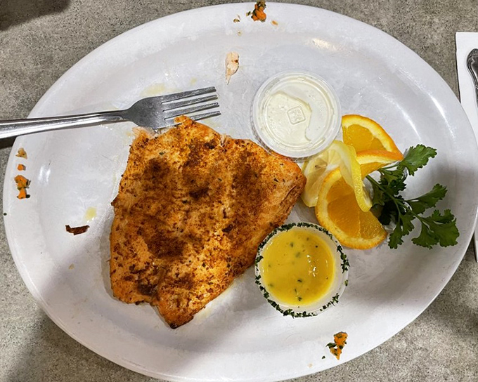 Perfectly seasoned salmon that flakes at the mere suggestion of your fork. The citrus garnish isn't just pretty&mdash;it's a flavor wingman.