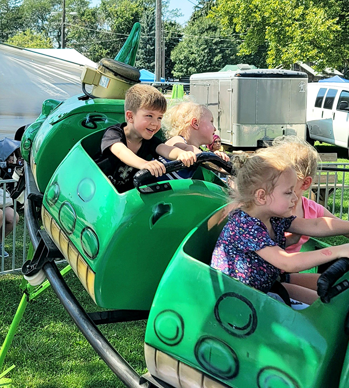 Childhood joy in motion! These young fairgoers experience the timeless delight of carnival rides, creating memories that will last far longer than cotton candy.