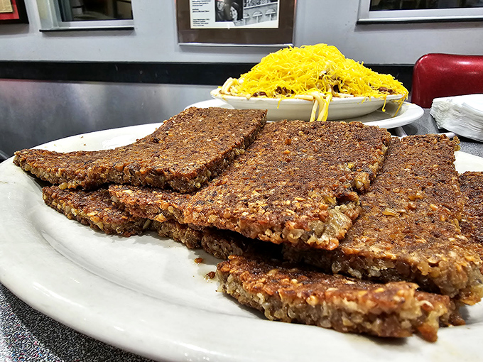 Scrapple slices fried to crispy perfection&mdash;a hearty breakfast tradition that turns humble ingredients into morning gold.