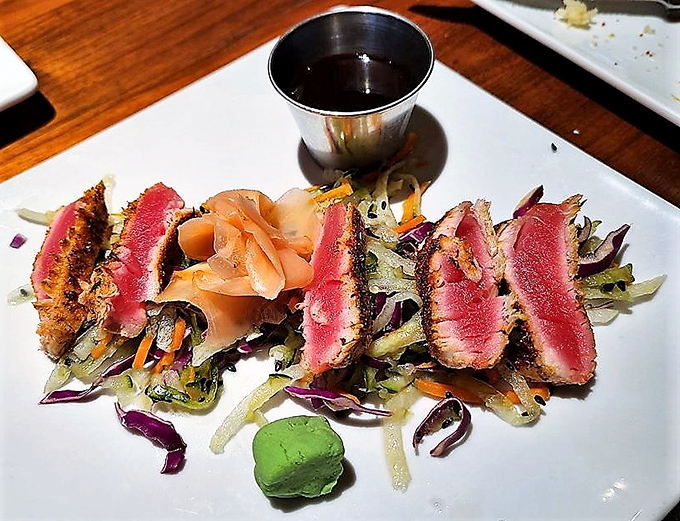 Seared ahi tuna that's dressed better than most people at the theater &ndash; rare in the middle and accessorized with wasabi.
