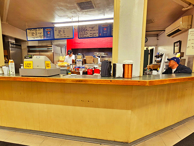 Behind this counter, breakfast dreams become delicious reality with the efficiency of a well-rehearsed Broadway show.