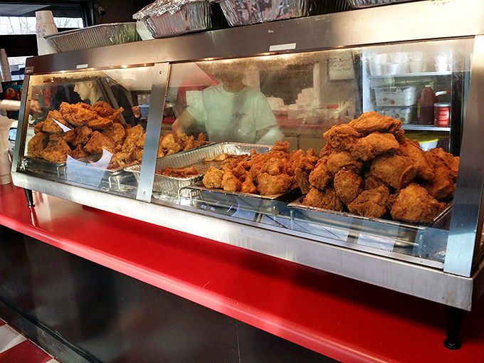 The heat lamp glow illuminating trays of golden fried chicken—nature's most perfect food group according to Southern nutritionists everywhere.