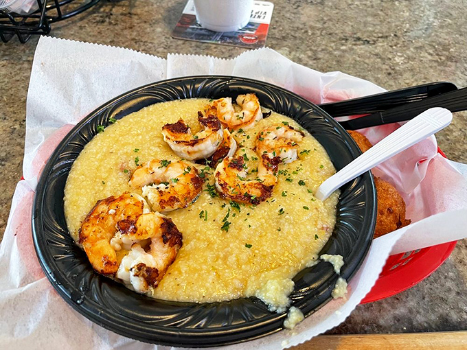 Southern comfort meets coastal luxury. Creamy grits cradle perfectly seared shrimp in this dish that whispers, "Slow down and savor me."
