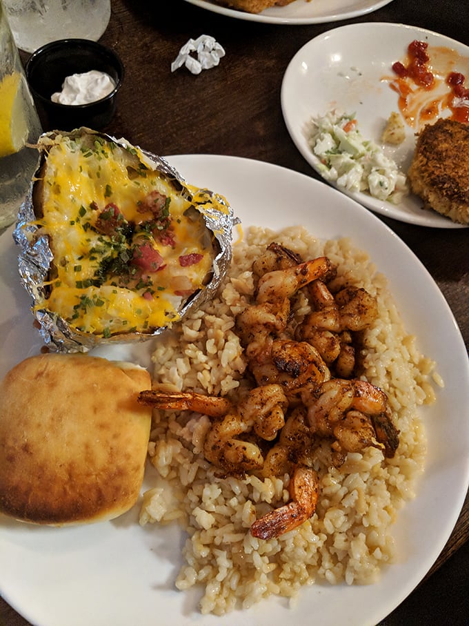 Grilled shrimp over rice with a loaded baked potato on the side. The seafood doesn't have to be fried to be phenomenal.
